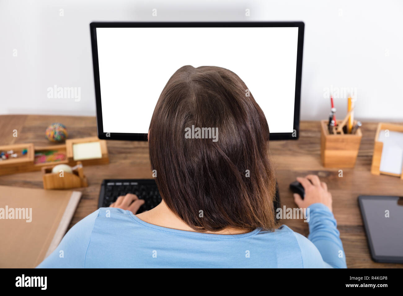 Woman Sitting In Front Of Desktop Stock Photo - Alamy