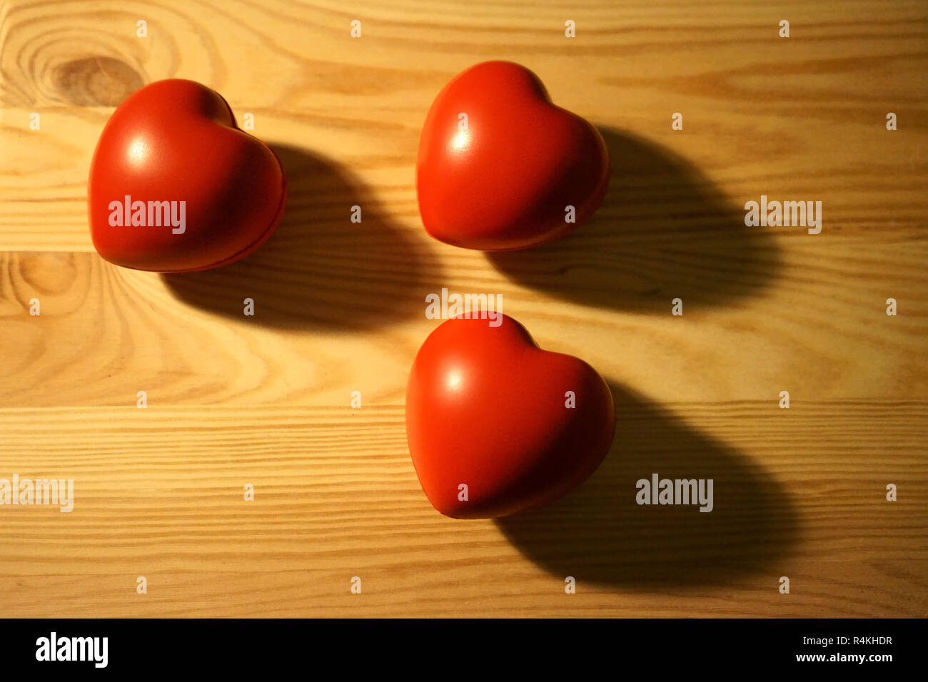 Three red heart and and their shadows Stock Photo - Alamy