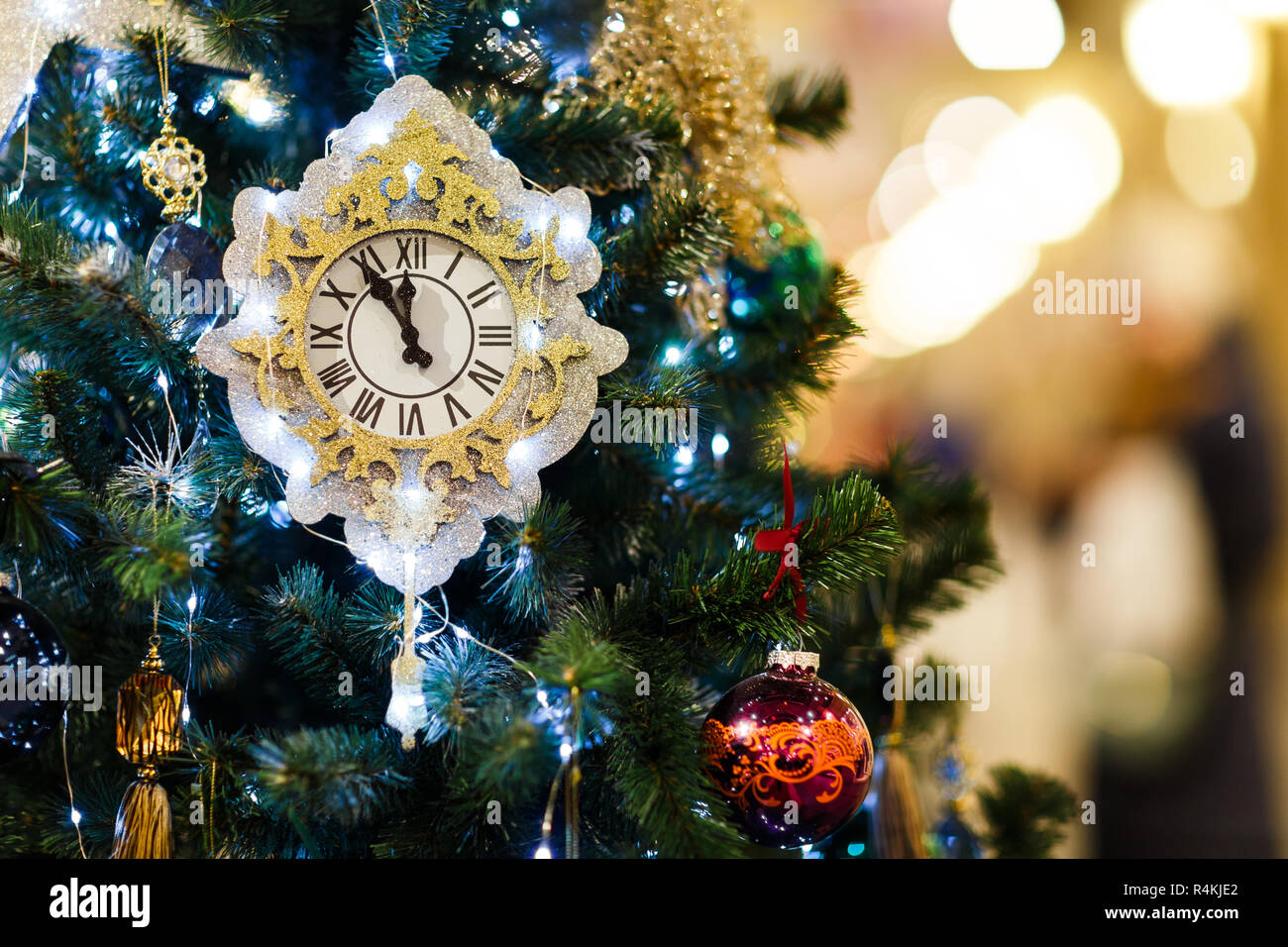 Image of decorated Christmas tree with clock, blue balls in store Stock ...