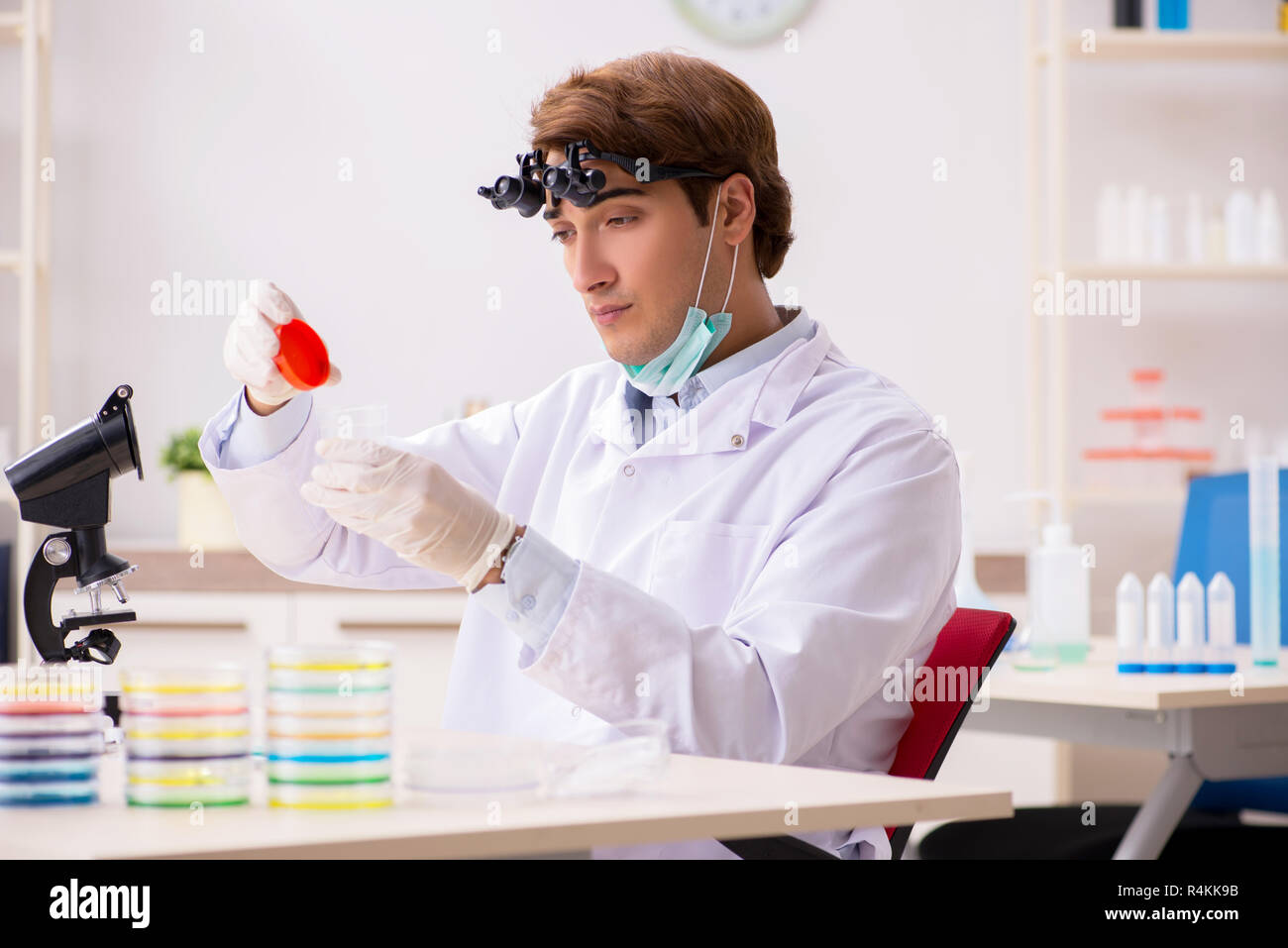 Young chemist working in the lab Stock Photo - Alamy