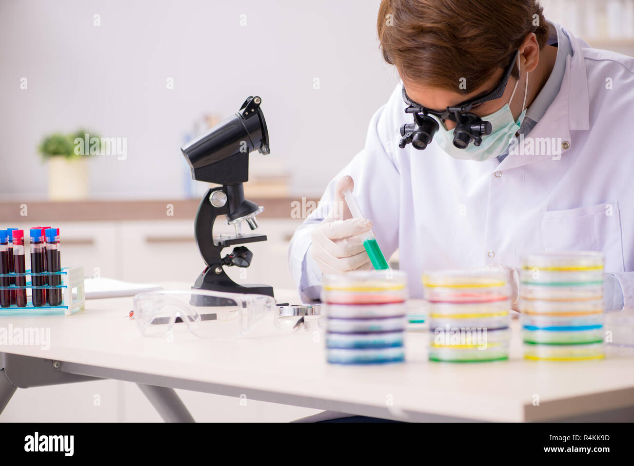 Young chemist working in the lab Stock Photo - Alamy