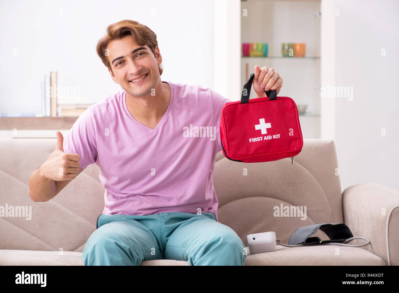 Sick man at home with first aid kit Stock Photo - Alamy