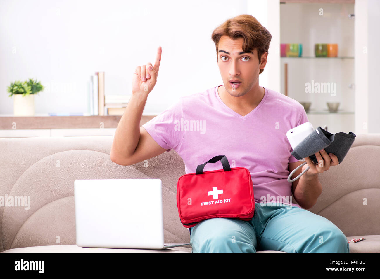 Sick man at home with first aid kit Stock Photo - Alamy