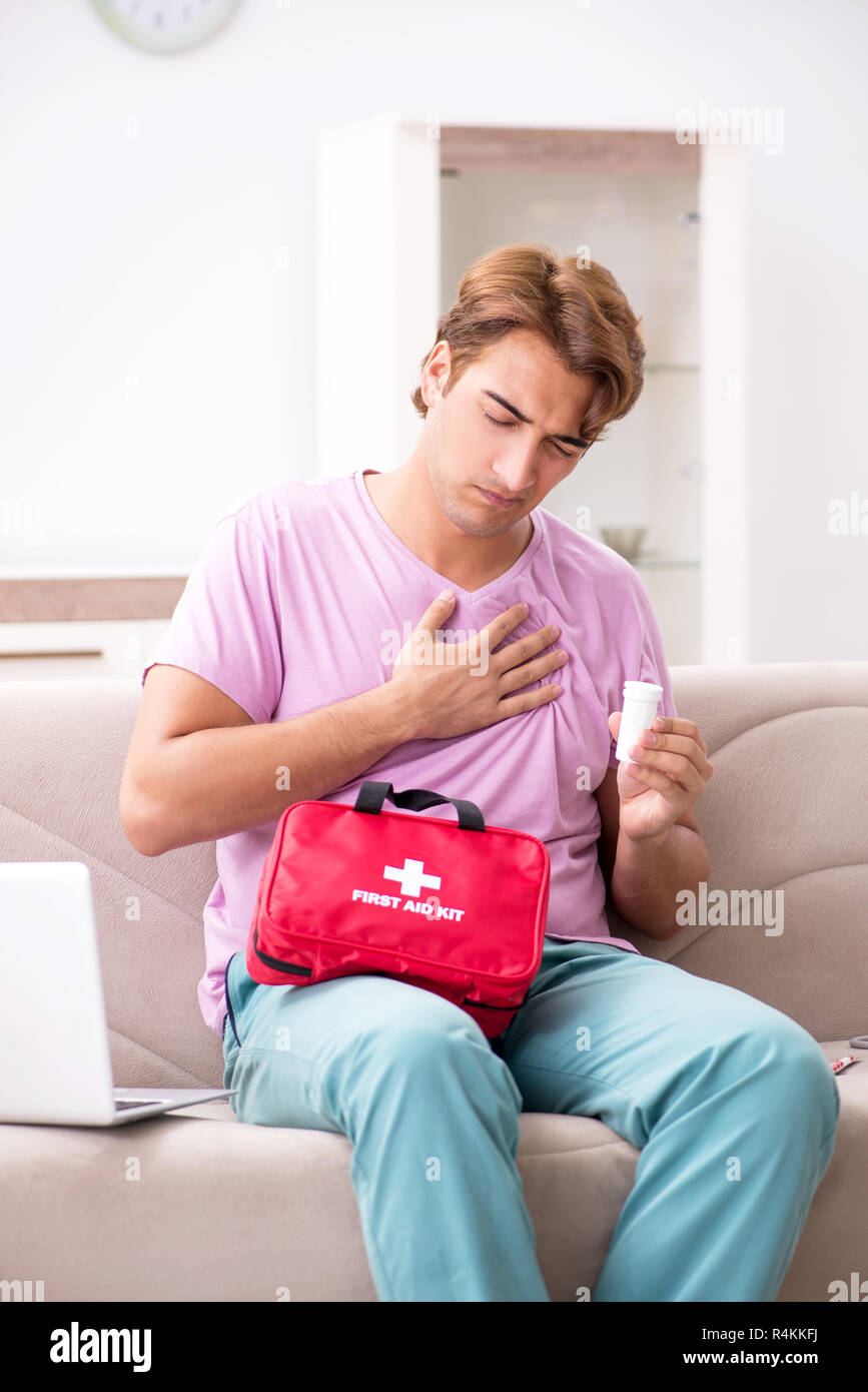 Sick man at home with first aid kit Stock Photo - Alamy