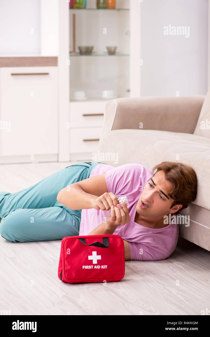 Sick man at home with first aid kit Stock Photo - Alamy