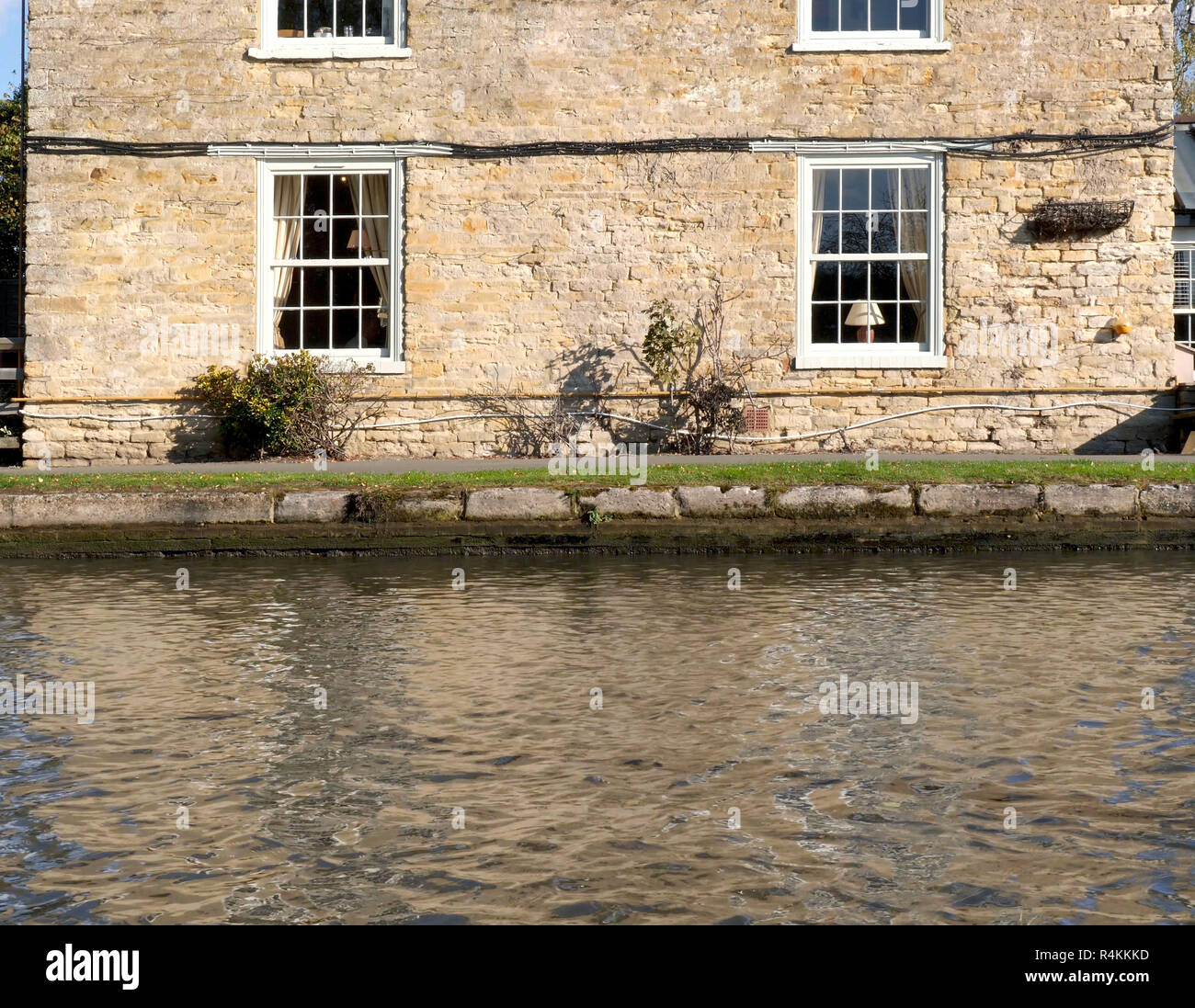 wide angle day view of canal river with village building on its coast ...