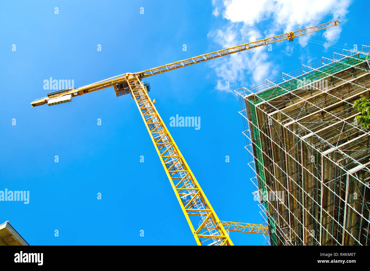 yellow crane builds a construction Stock Photo - Alamy