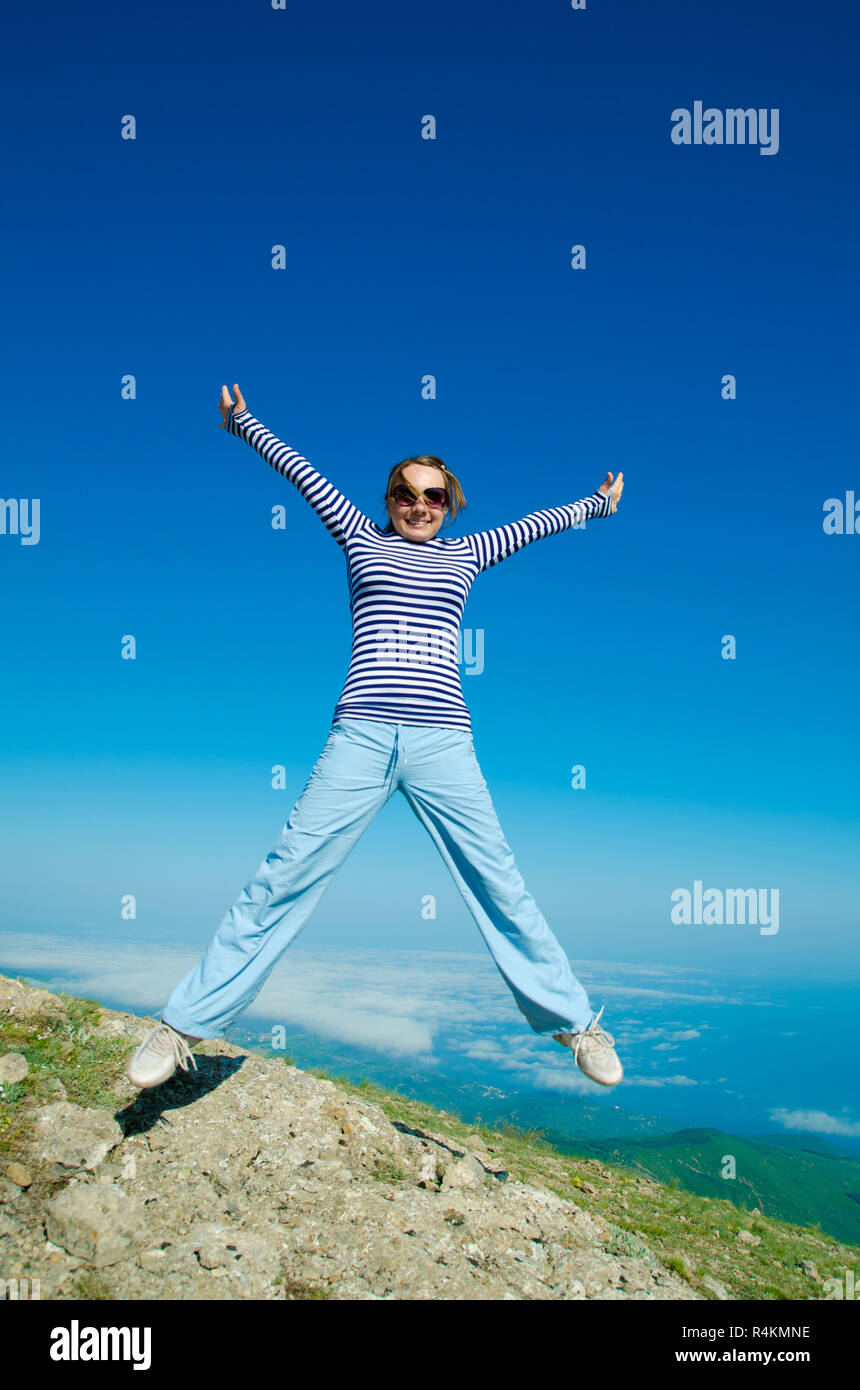 young woman jumping in mountain Stock Photo - Alamy