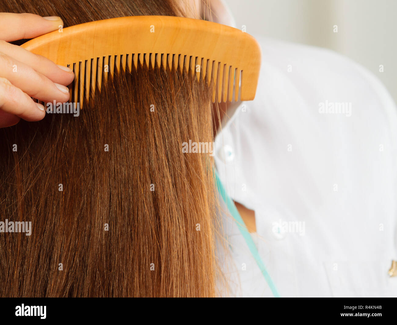 Hair care concept. Closeup straight brown healthy shiny hair and hand ...