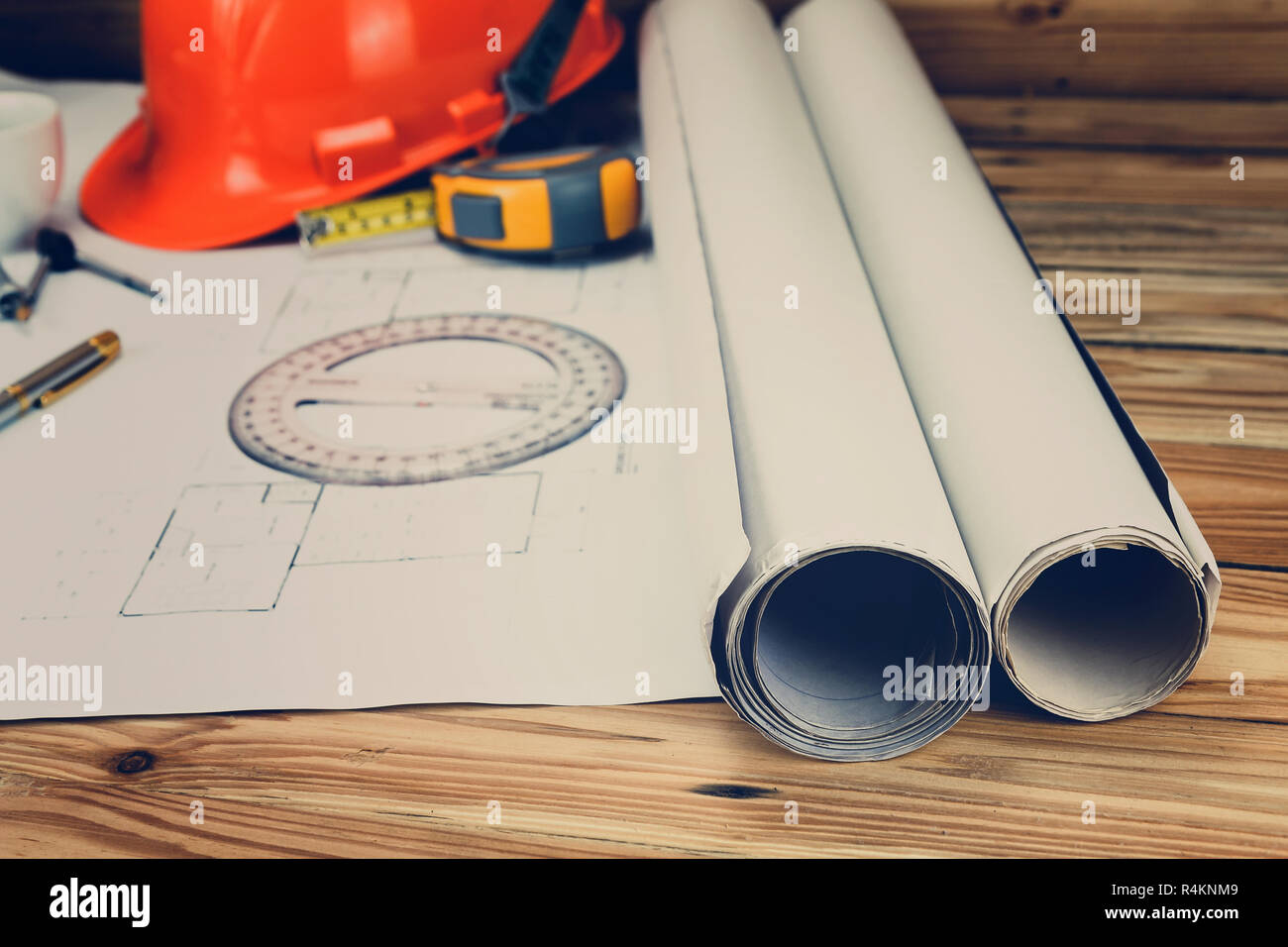 Blueprint with measurement tool and helmet on wooden desk Stock Photo ...