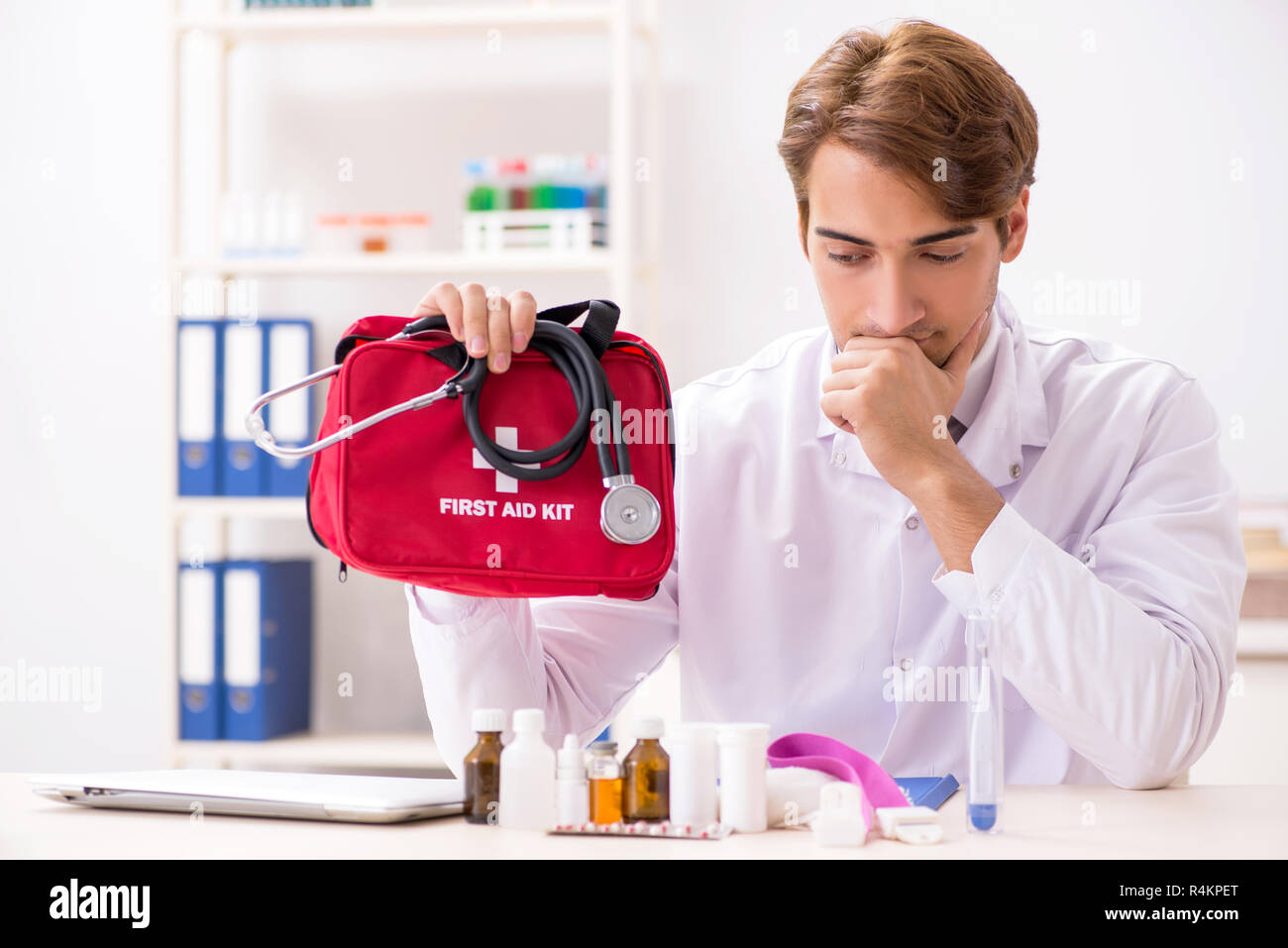 Young doctor with first aid kit in hospital Stock Photo - Alamy