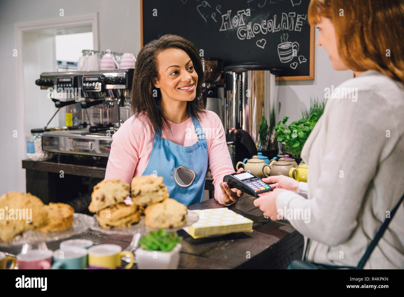 Paying At A Cafe Stock Photo - Alamy
