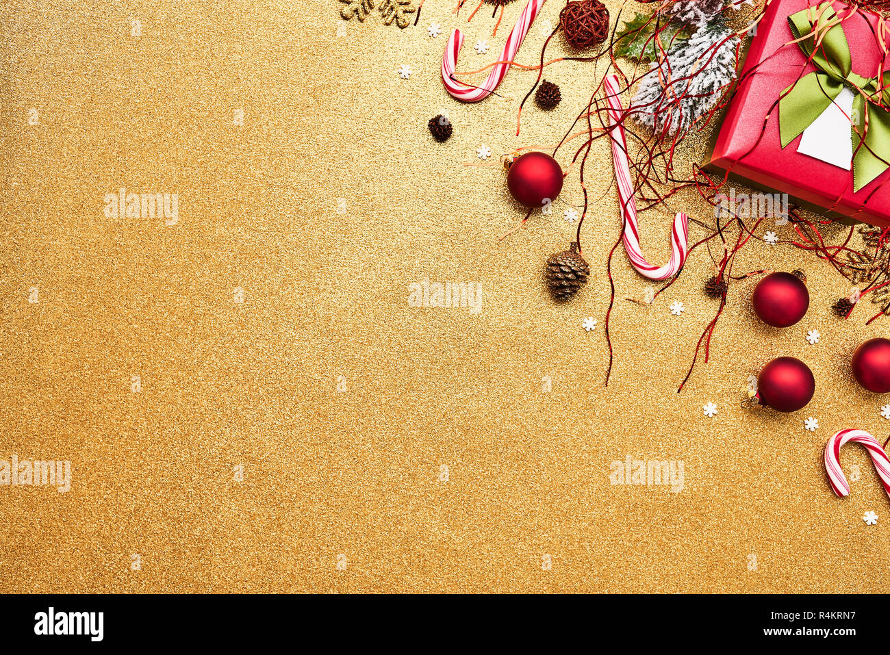 Beautiful christmas red deco baubles with gift box on golden glitter ...