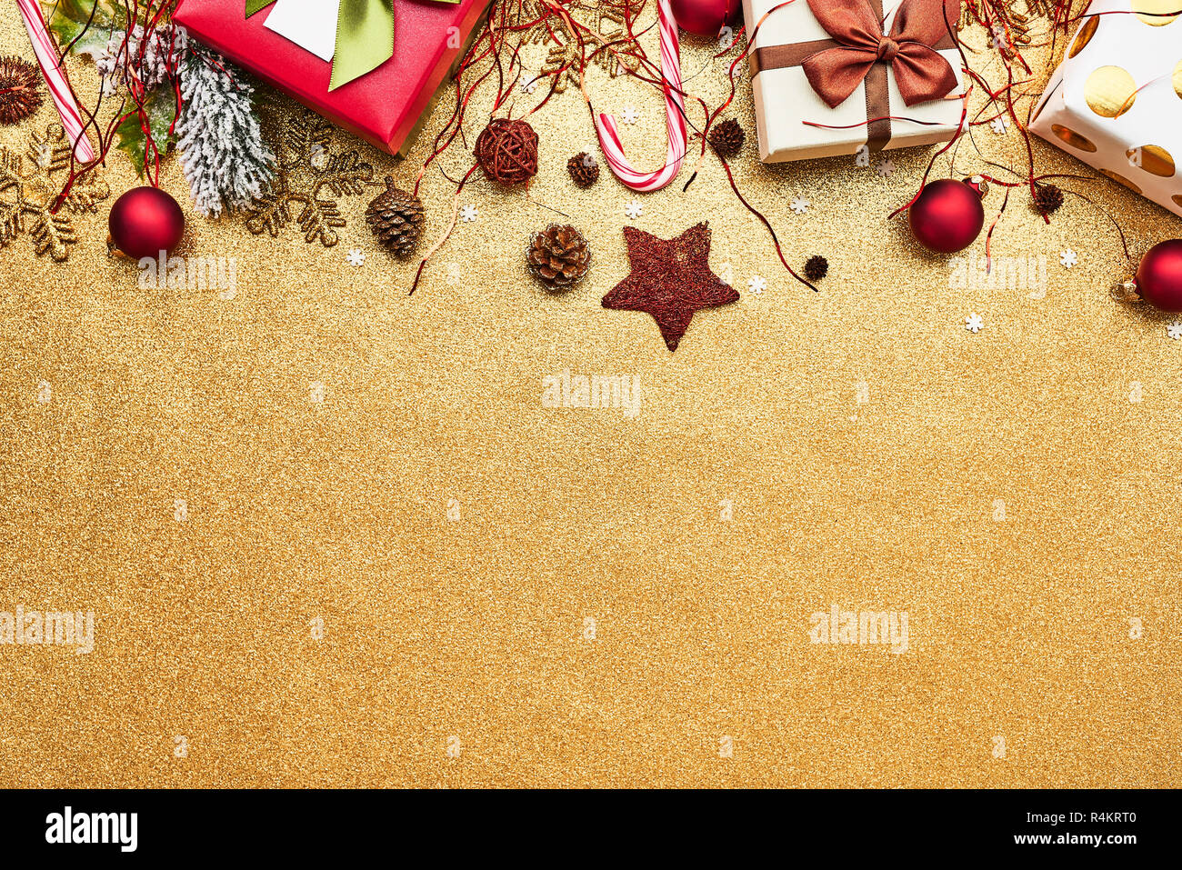 Beautiful christmas red deco baubles with gifts on golden glitter ...