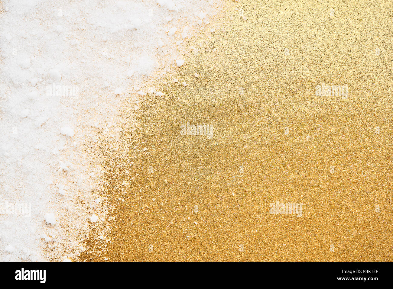 White powdery snow on golden glitter background. Snow and glitter for ...