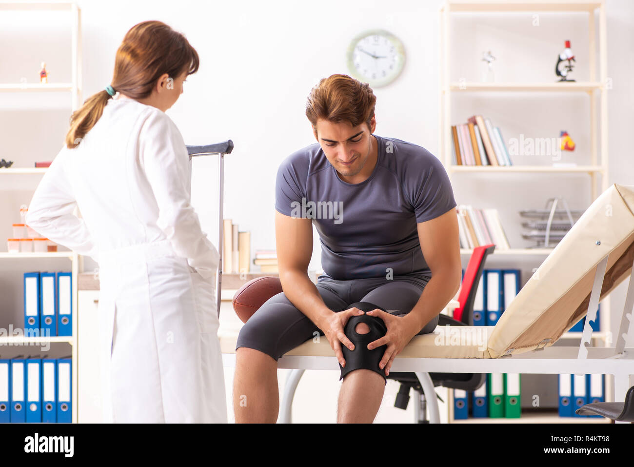 Young male patient visiting female doctor traumatologist Stock Photo ...