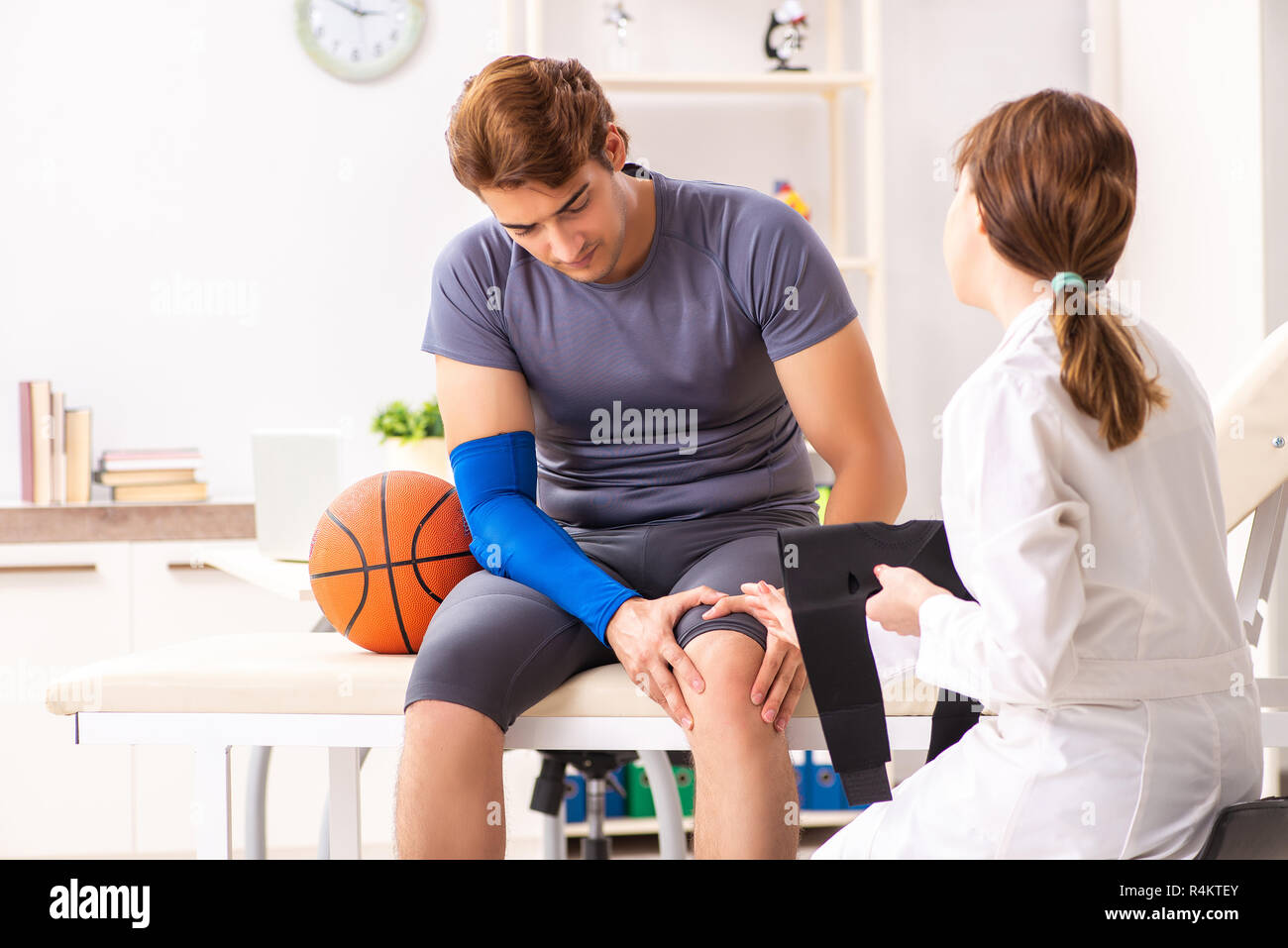 Handsome basketball player visiting female doctor traumatologist Stock ...