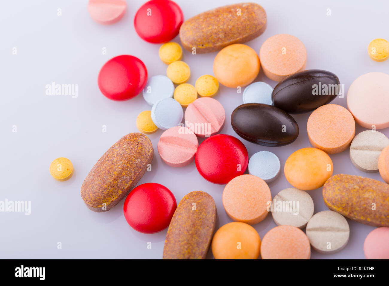 Tablets pills capsule heap mix therapy drugs, over a white background ...
