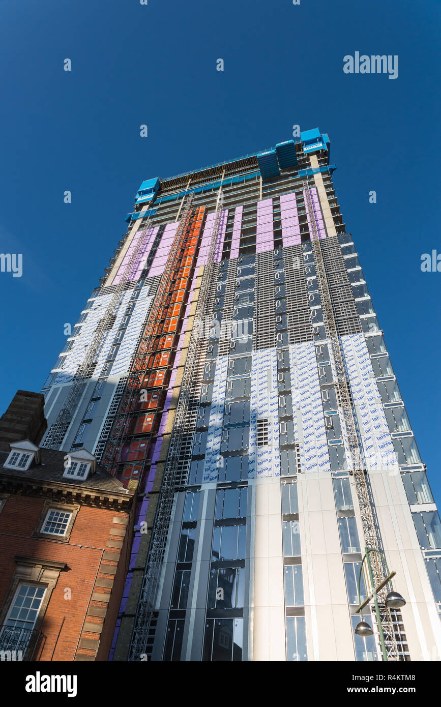 Construction of tall building showing structure and insulation and ...