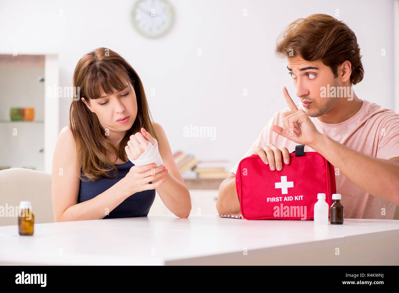 Young family getting treatment with first aid kit Stock Photo - Alamy