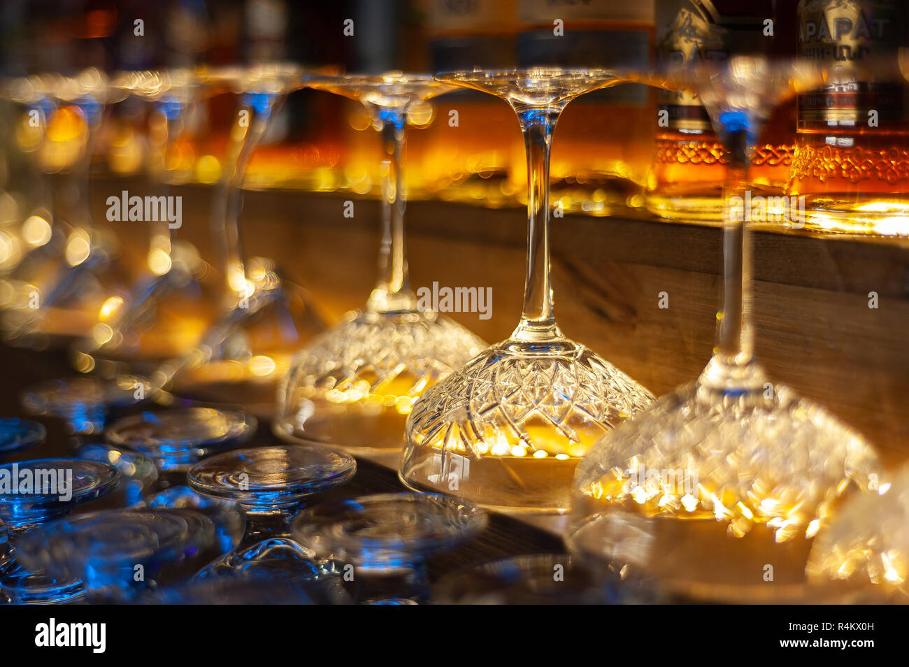 glass row bar counter . Many empty wineglasses. Yellow warm light Stock ...