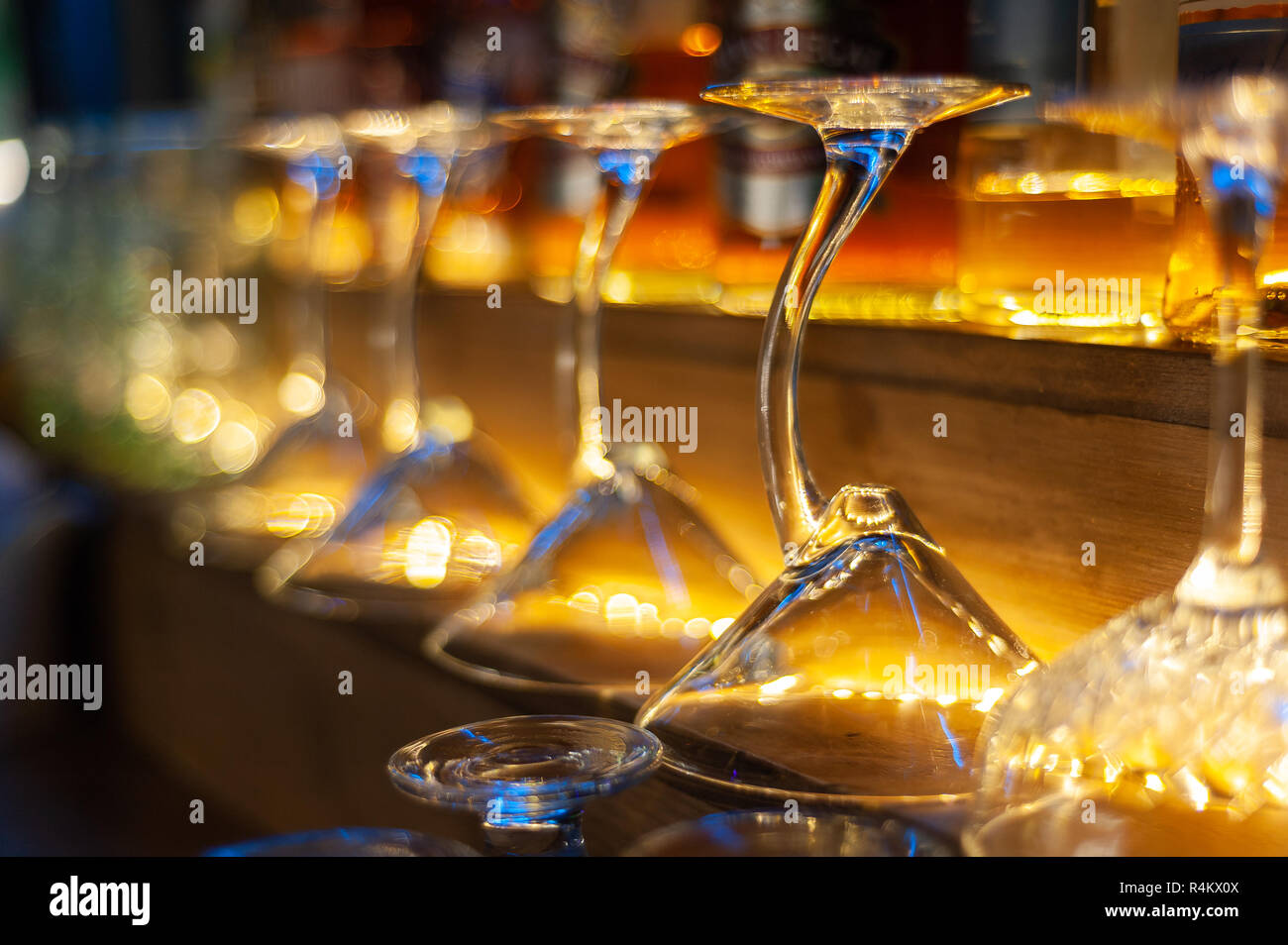 glass row bar counter . Many empty wineglasses. Yellow warm light Stock ...