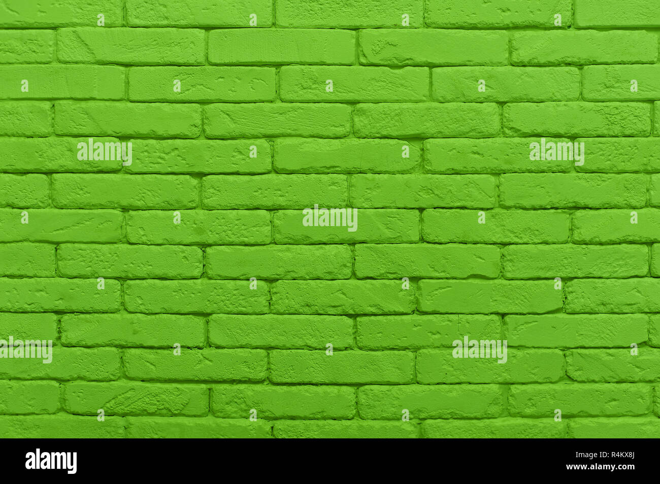 green brick wall painted at saturated lime colour. closeup texture ...
