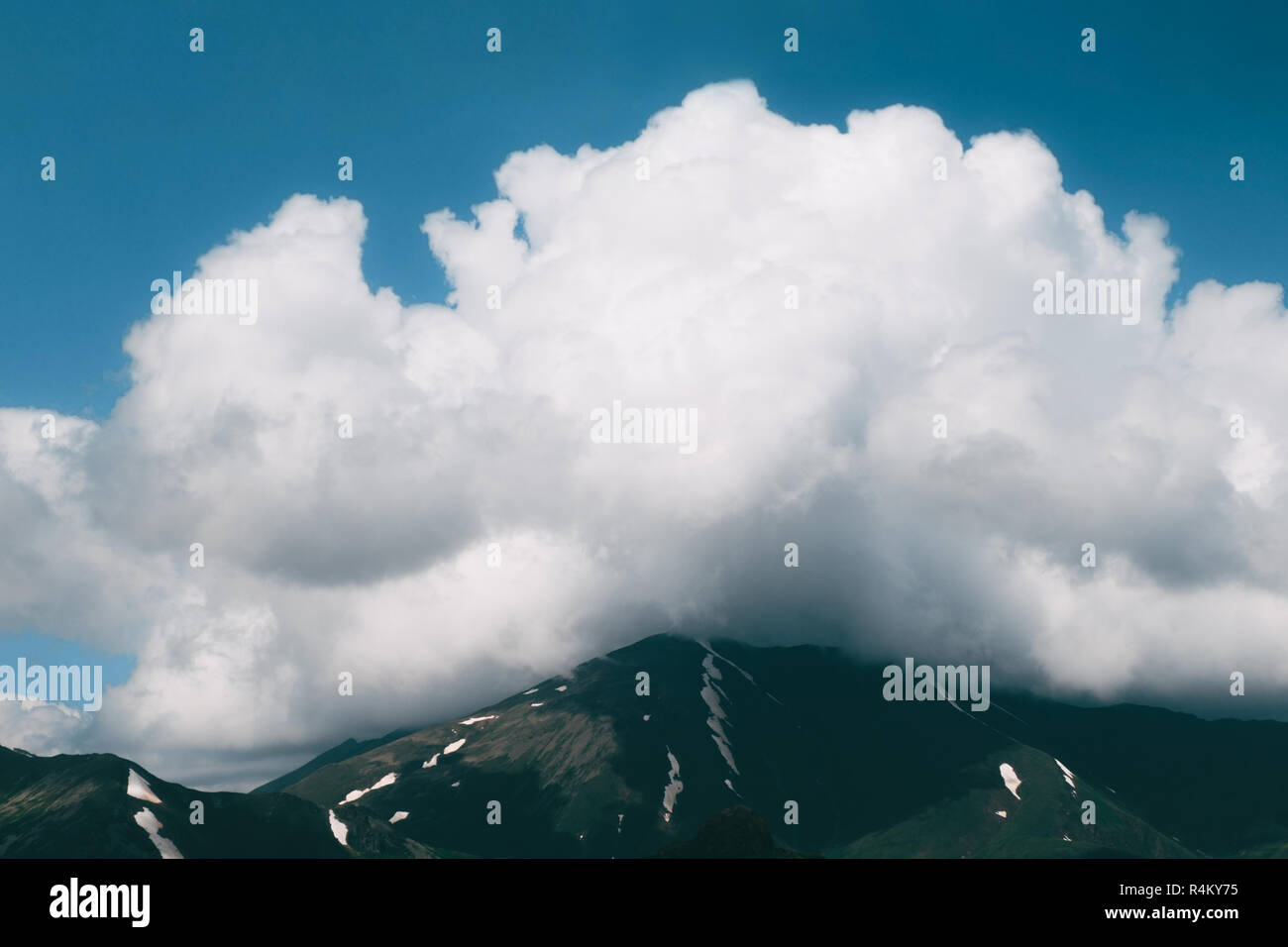 snowy green mountain hills spring landscape with blue cloudy sky Stock ...