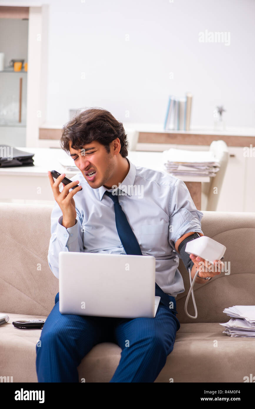 Man under stress measuring his blood pressure Stock Photo - Alamy