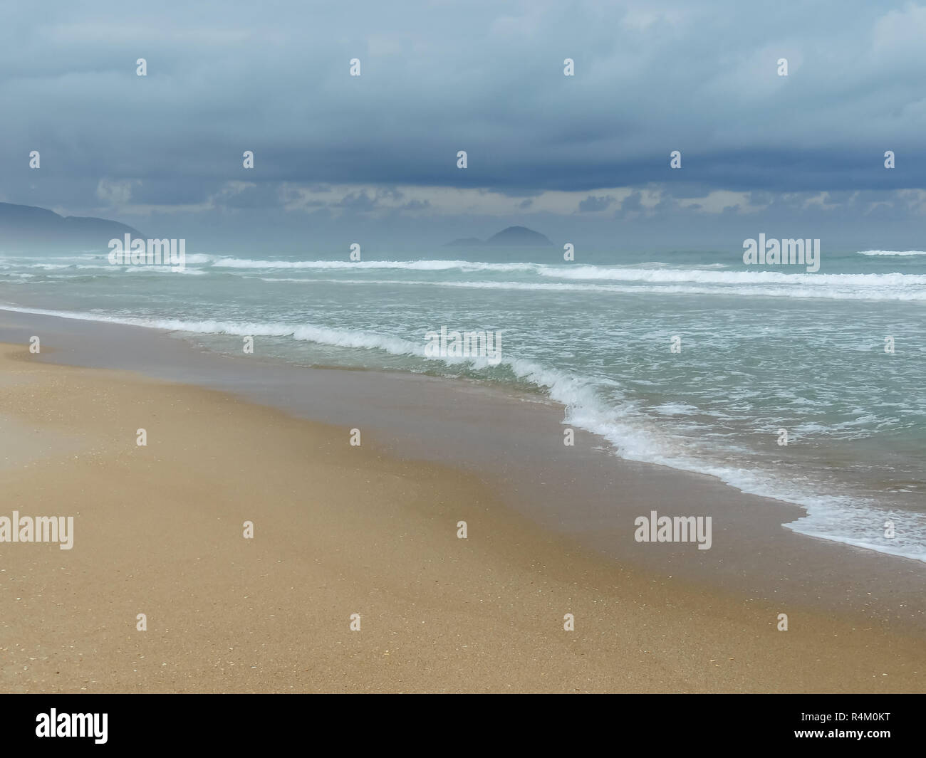 Eye level view of a beach with some low waves in the Florianópolis ...