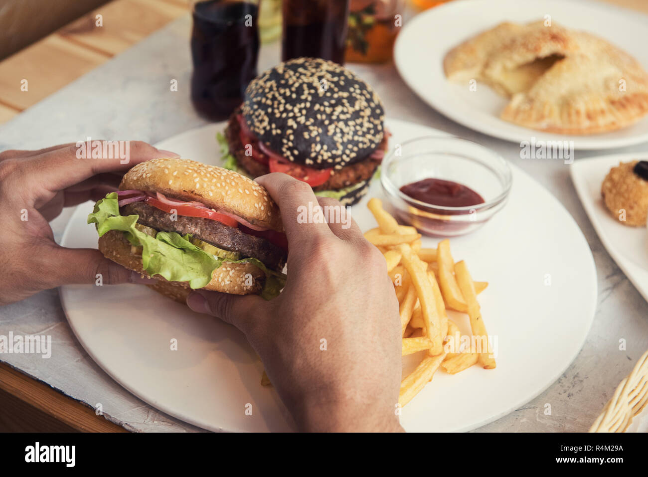 Man eating burgers Stock Photo - Alamy