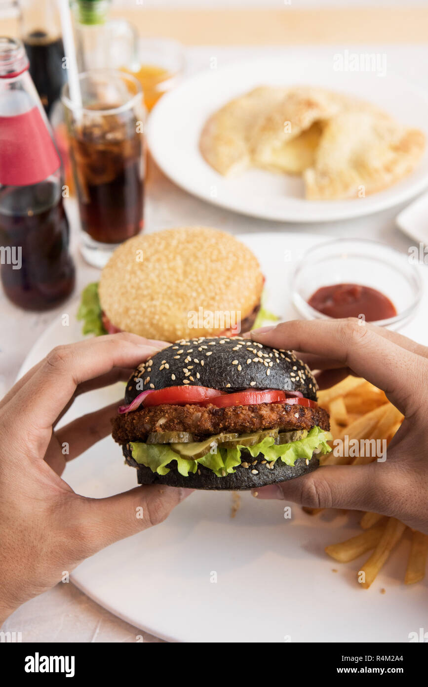 Man eating burgers Stock Photo - Alamy