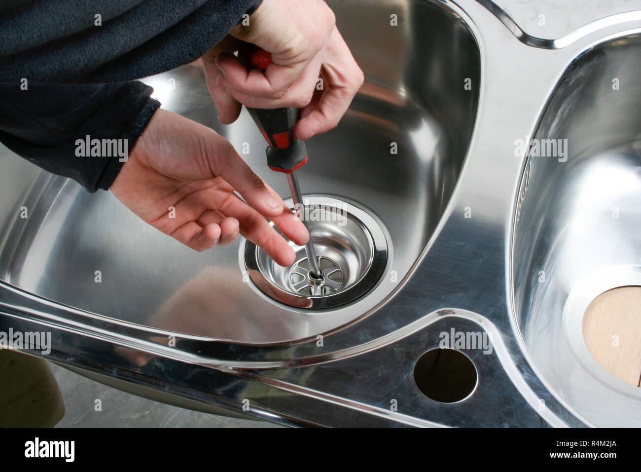 Construction worker installing a kitchen sink Stock Photo - Alamy