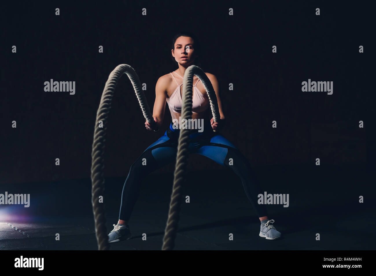 beautiful athletic woman working out with ropes box gym copyspace ...