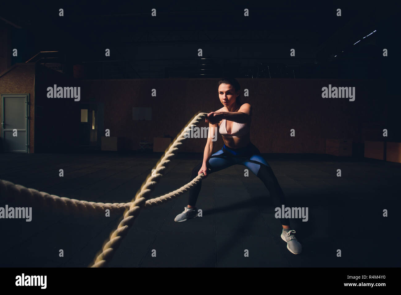 beautiful athletic woman working out with ropes box gym copyspace ...