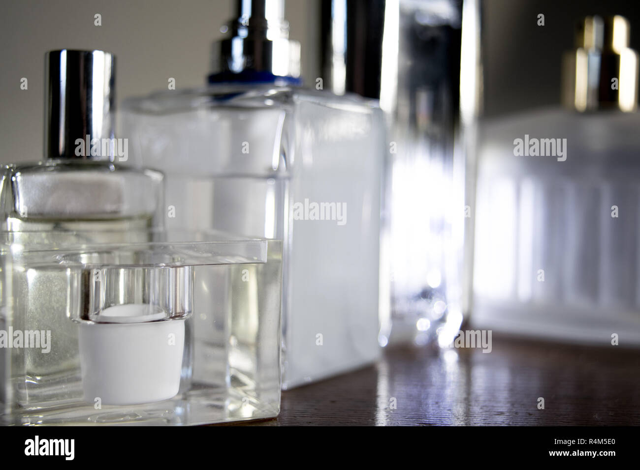 perfume bottles illumined with chiaroscuro light Stock Photo - Alamy