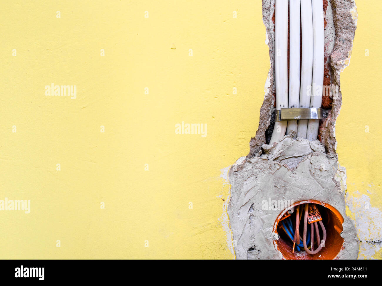 New electrical installation, socket and electrical wires on the wall ...