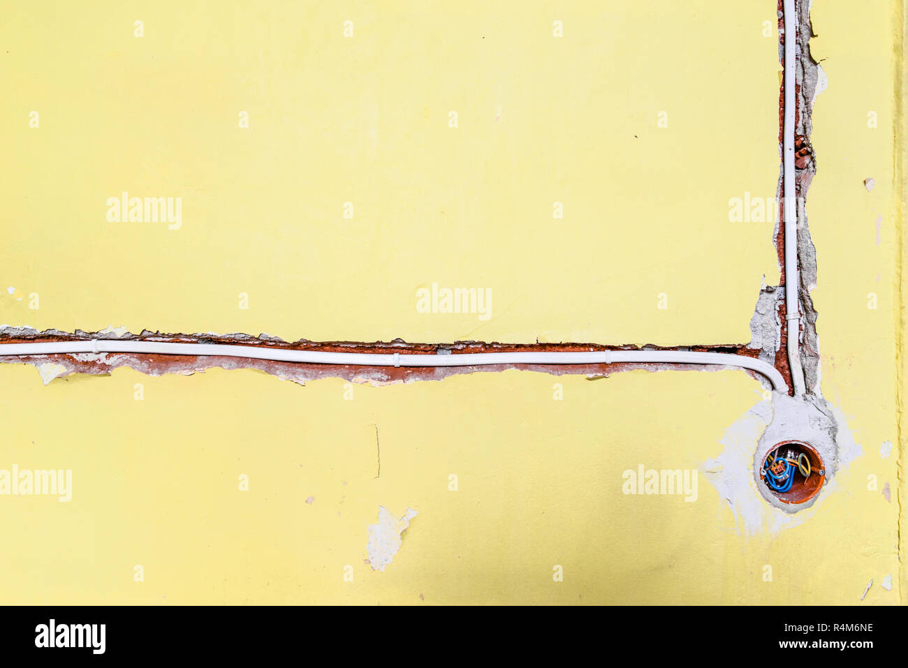 New electrical installation, socket and electrical cables on the wall ...