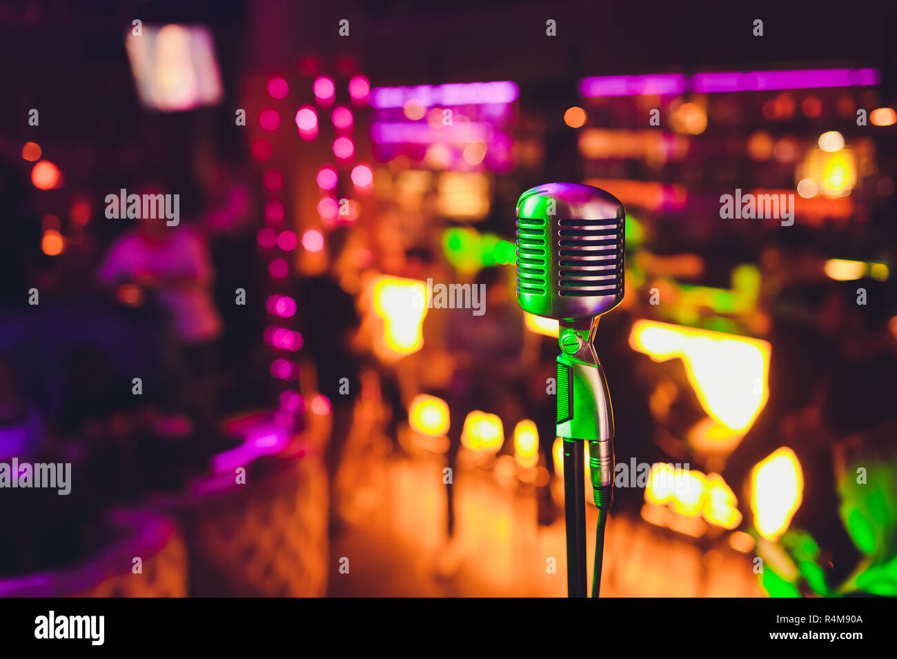 Retro microphone against blur colorful light restaurant background ...