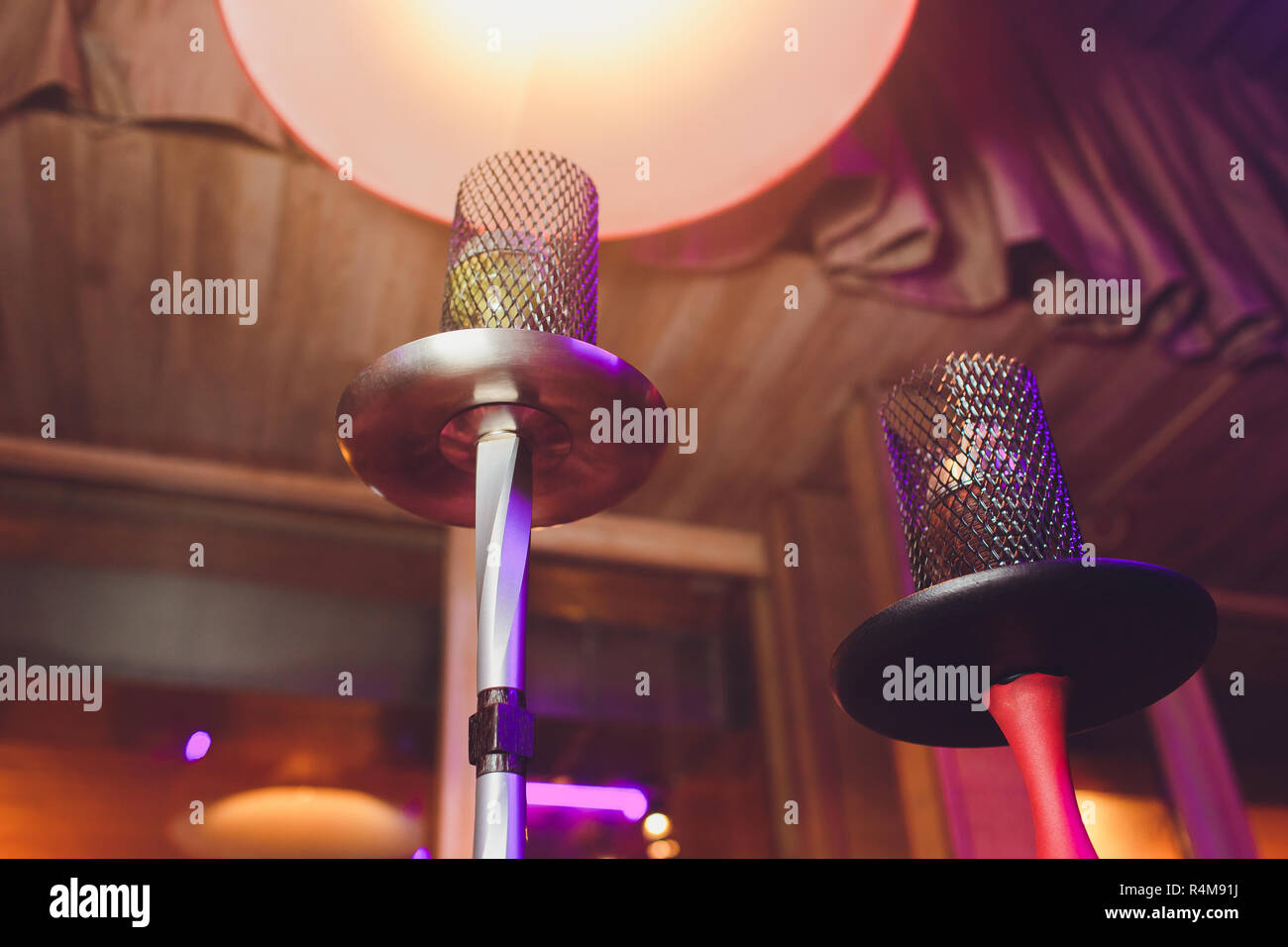 Group of black hookahs shisha on evening city background, blurred bokeh background. Modern ...