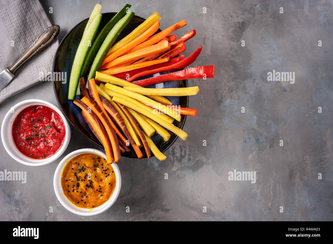 Colorful vegetable sticks in a cup on gray background. Copy space Stock ...