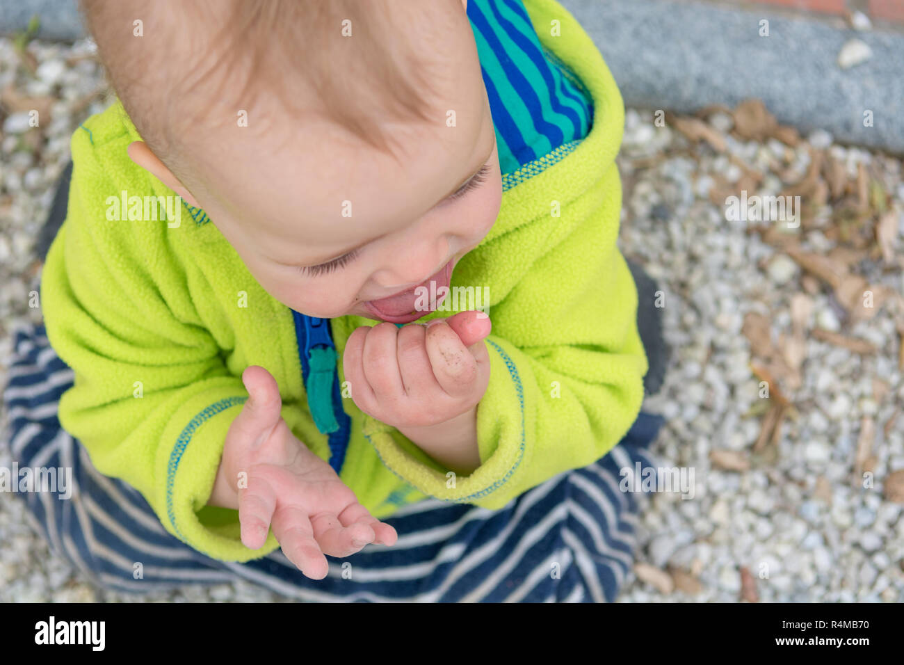 Drop down view of a child eating dirt Stock Photo - Alamy