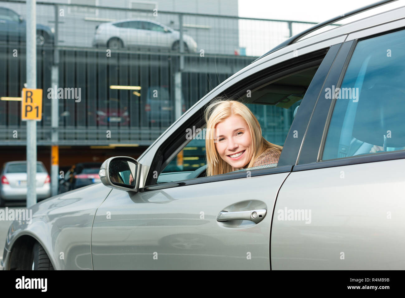 Woman back her car on a parking level Stock Photo - Alamy