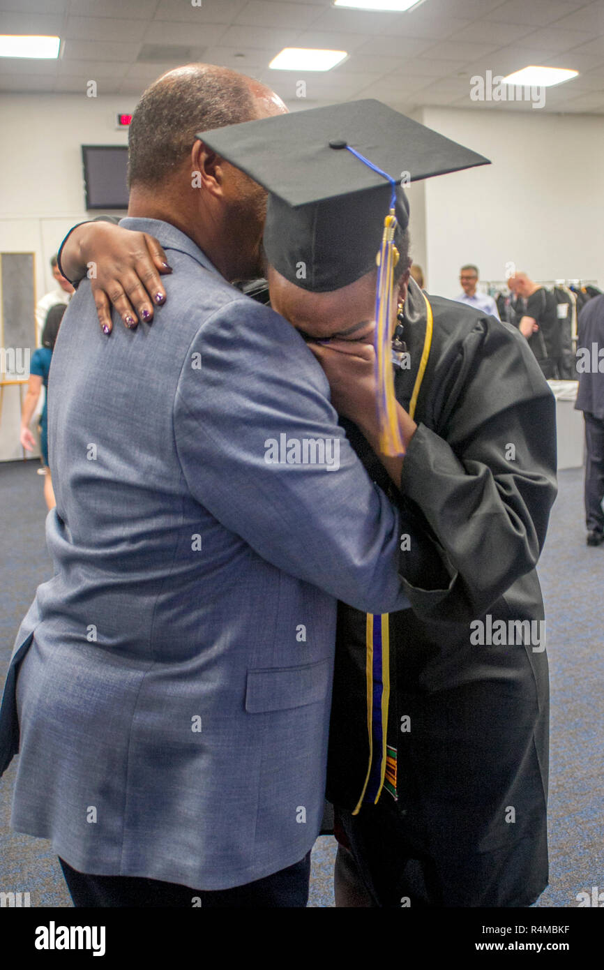 Overcome with happy emotion, an African American woman college graduate ...