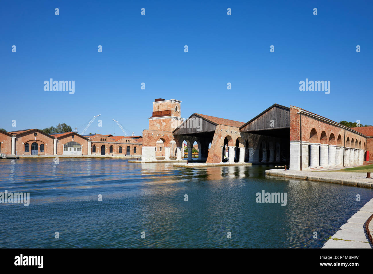 Venetian Arsenal with docks, canal and industrial building in a sunny ...