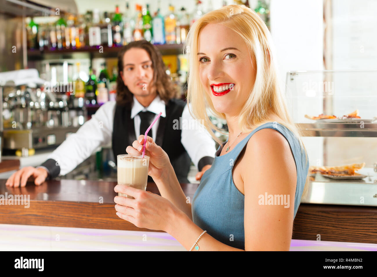 Barista with client in his cafe or coffeeshop Stock Photo - Alamy