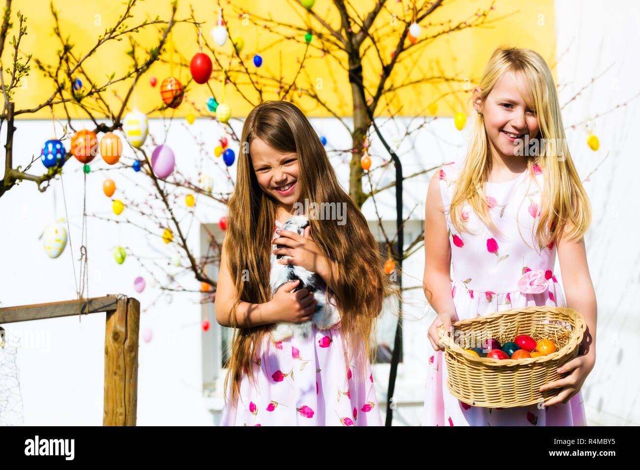 Girl on Easter egg hunt with living Easter Bunny Stock Photo - Alamy