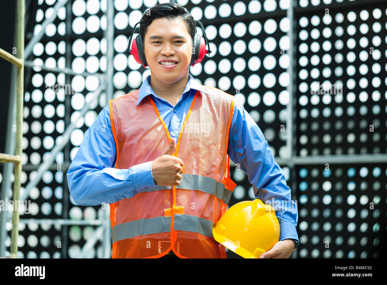 Asian Indonesian construction worker on building site Stock Photo - Alamy