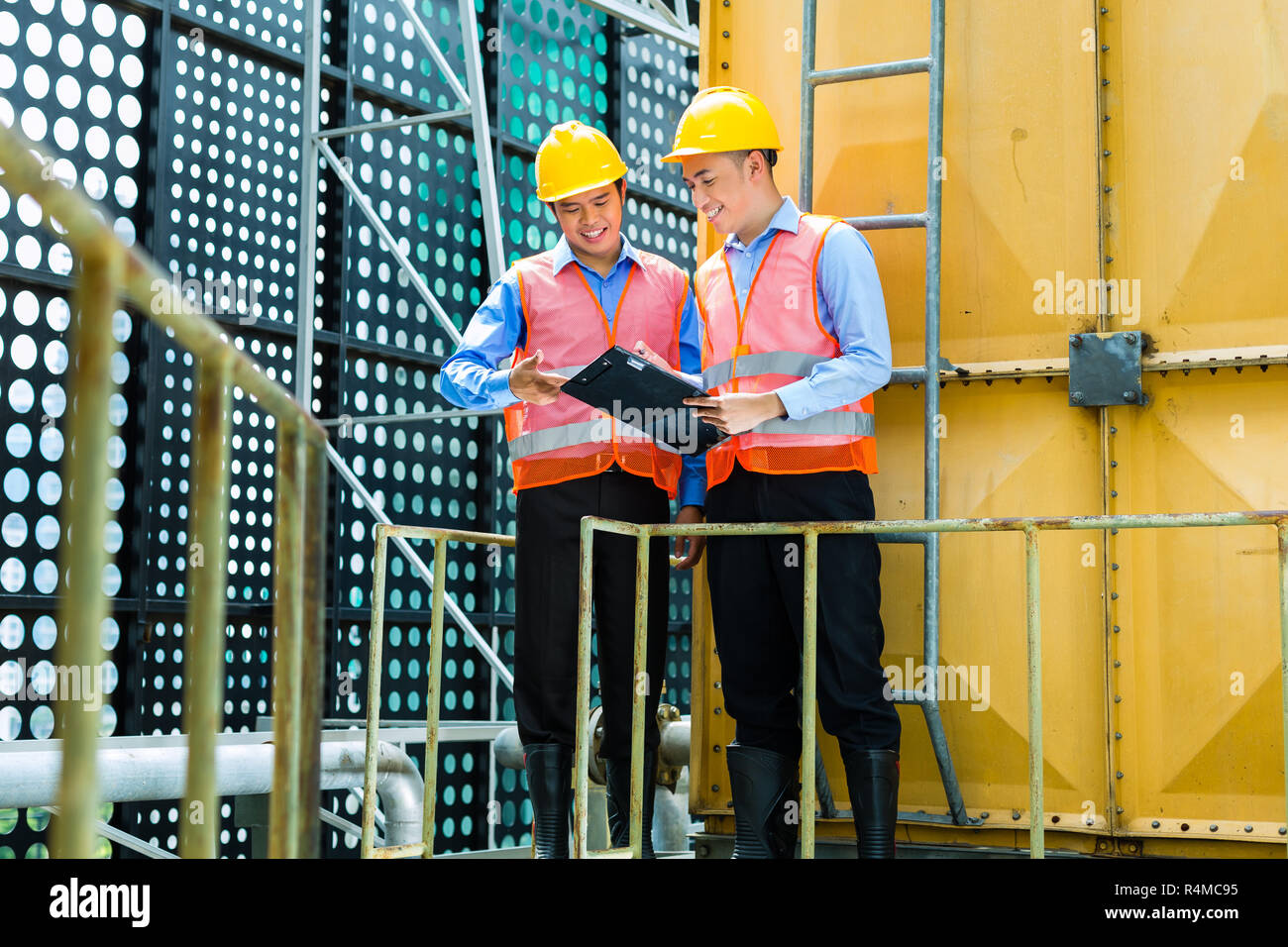 Asian Indonesian construction workers on building site Stock Photo - Alamy