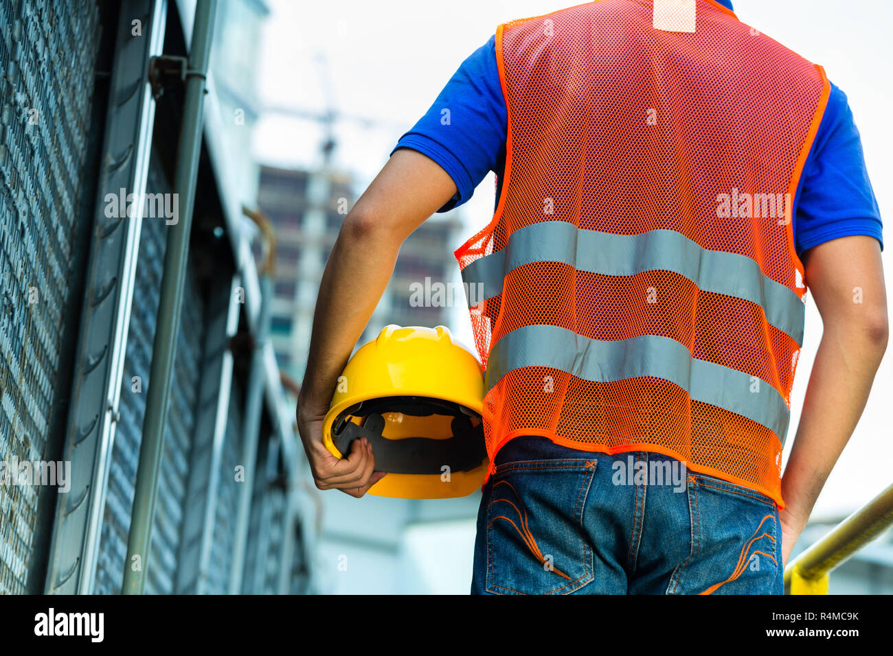 Asian Indonesian construction worker on building site Stock Photo - Alamy